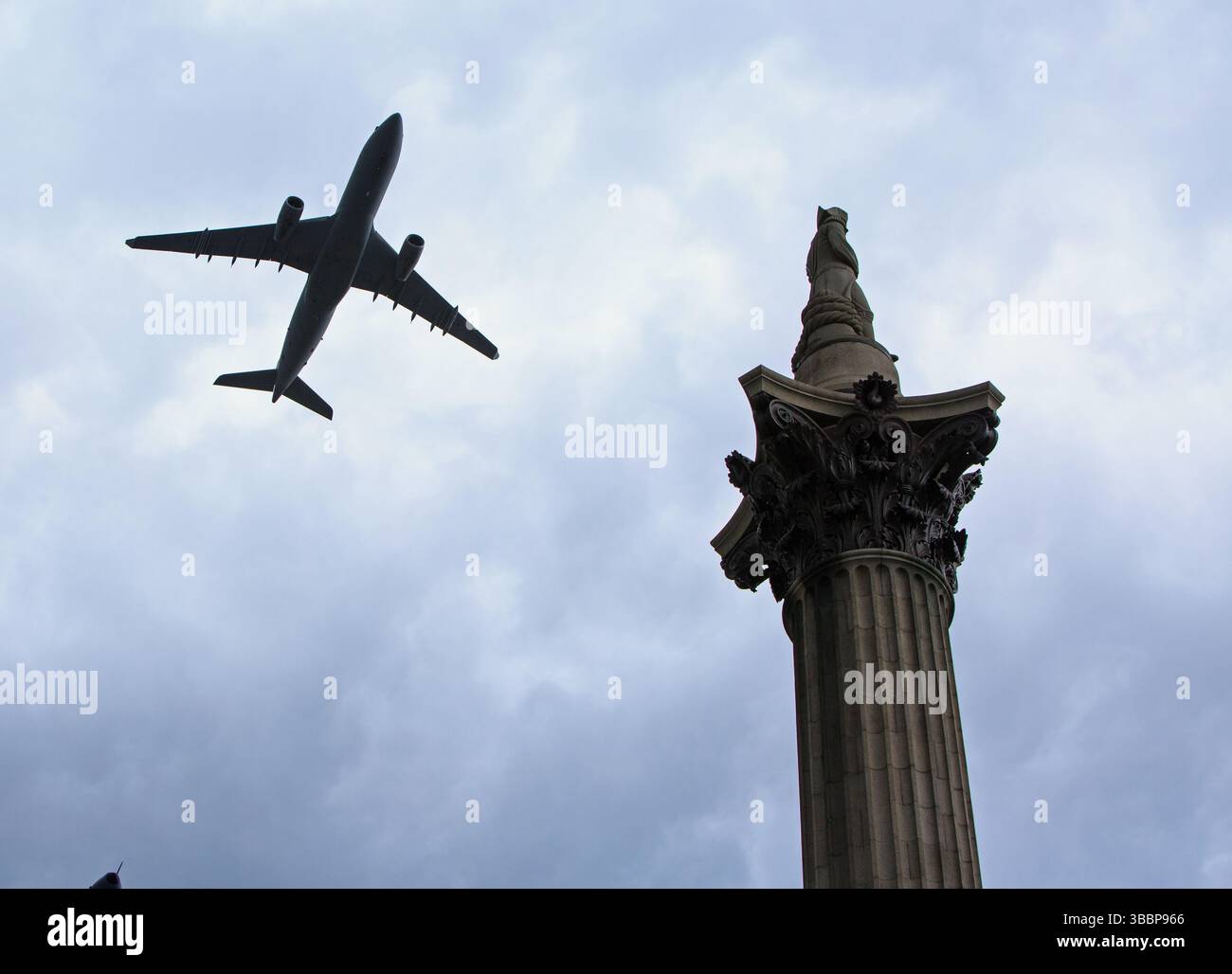 Large aeroplane with two fighter jets in mid-air flying over Nelsons ...