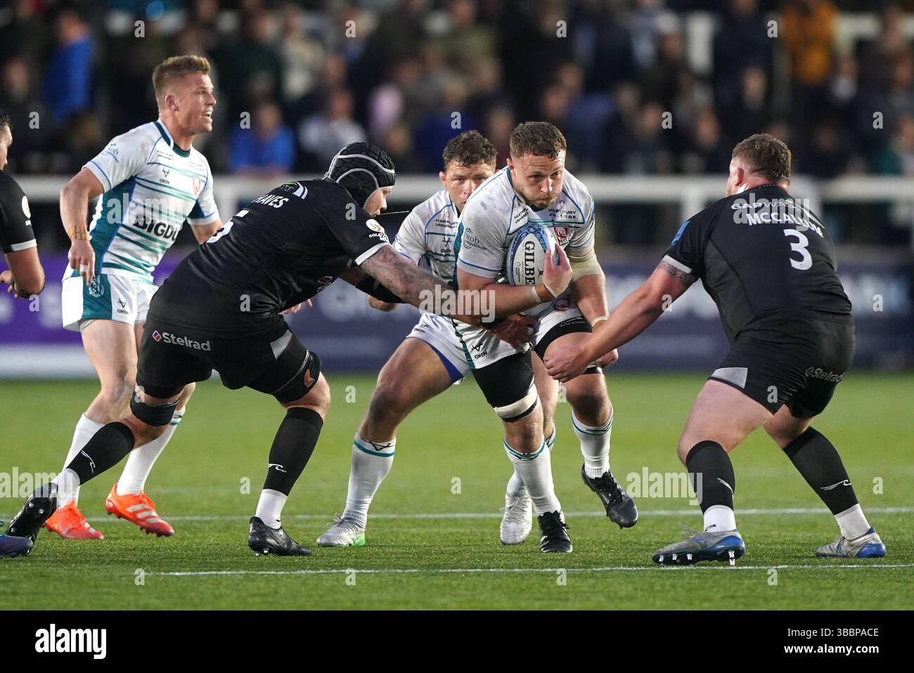 Gloucester's Ruan Ackermann (centre) is tackled by Newcastle Falcons ...