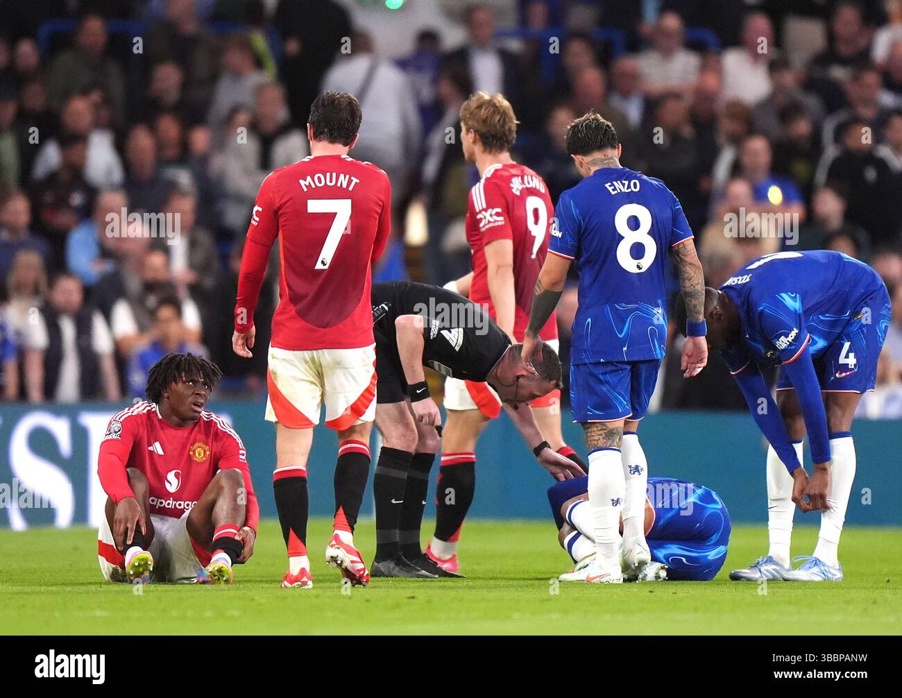 Manchester United's Patrick Dorgu (left) reacts to an injury during the ...