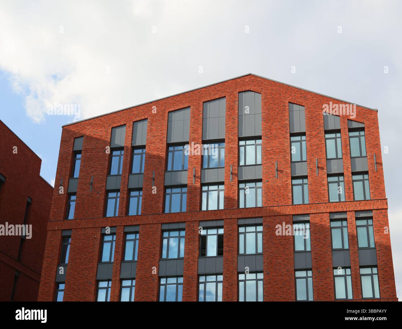 A contemporary modern brick building featuring large windows is ...