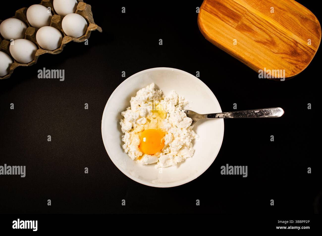 Process of making syrniki. Adding egg to cottage cheese. Top view on ...