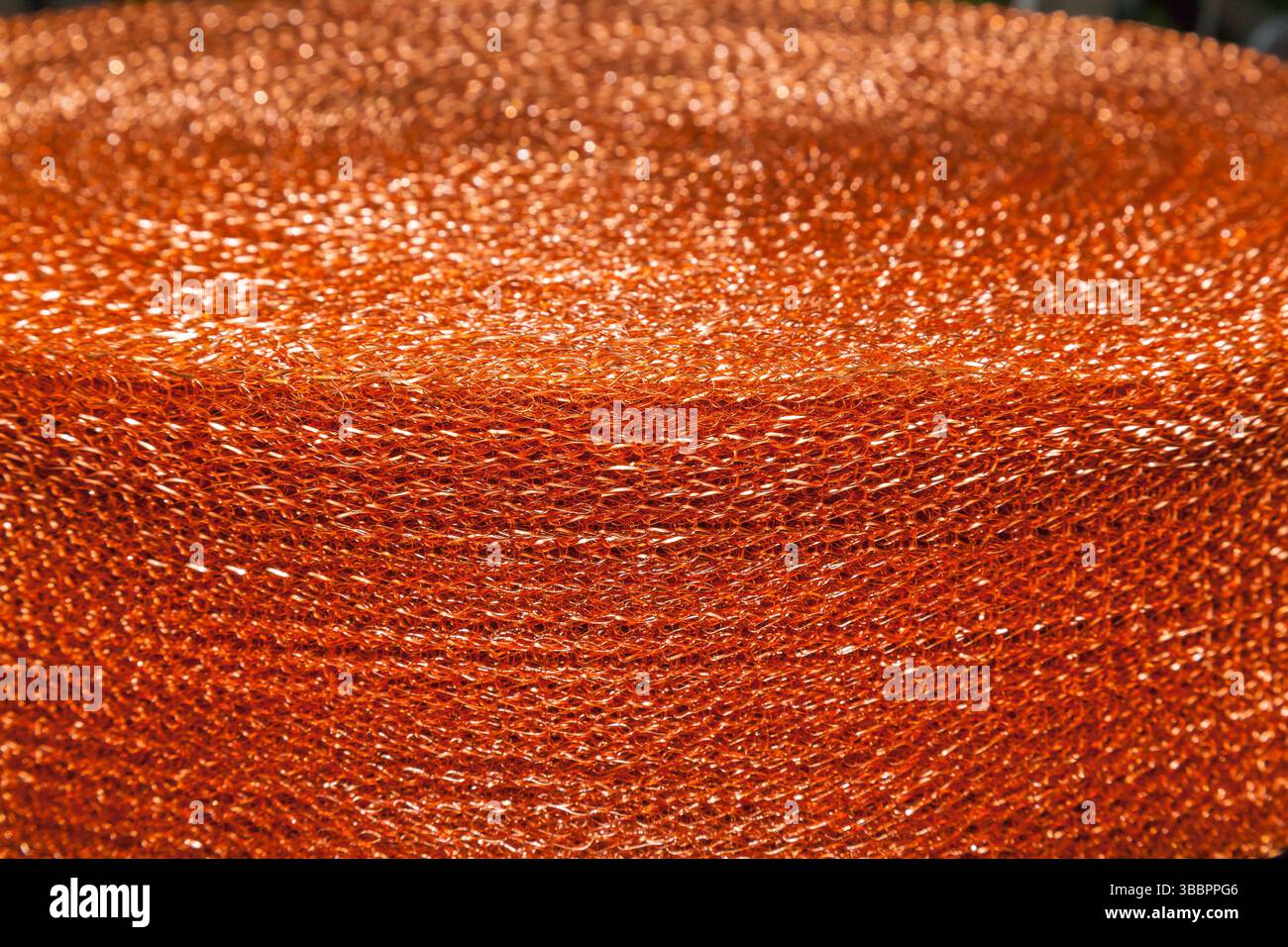 The texture of a soft copper mesh twisted into a roll Stock Photo - Alamy