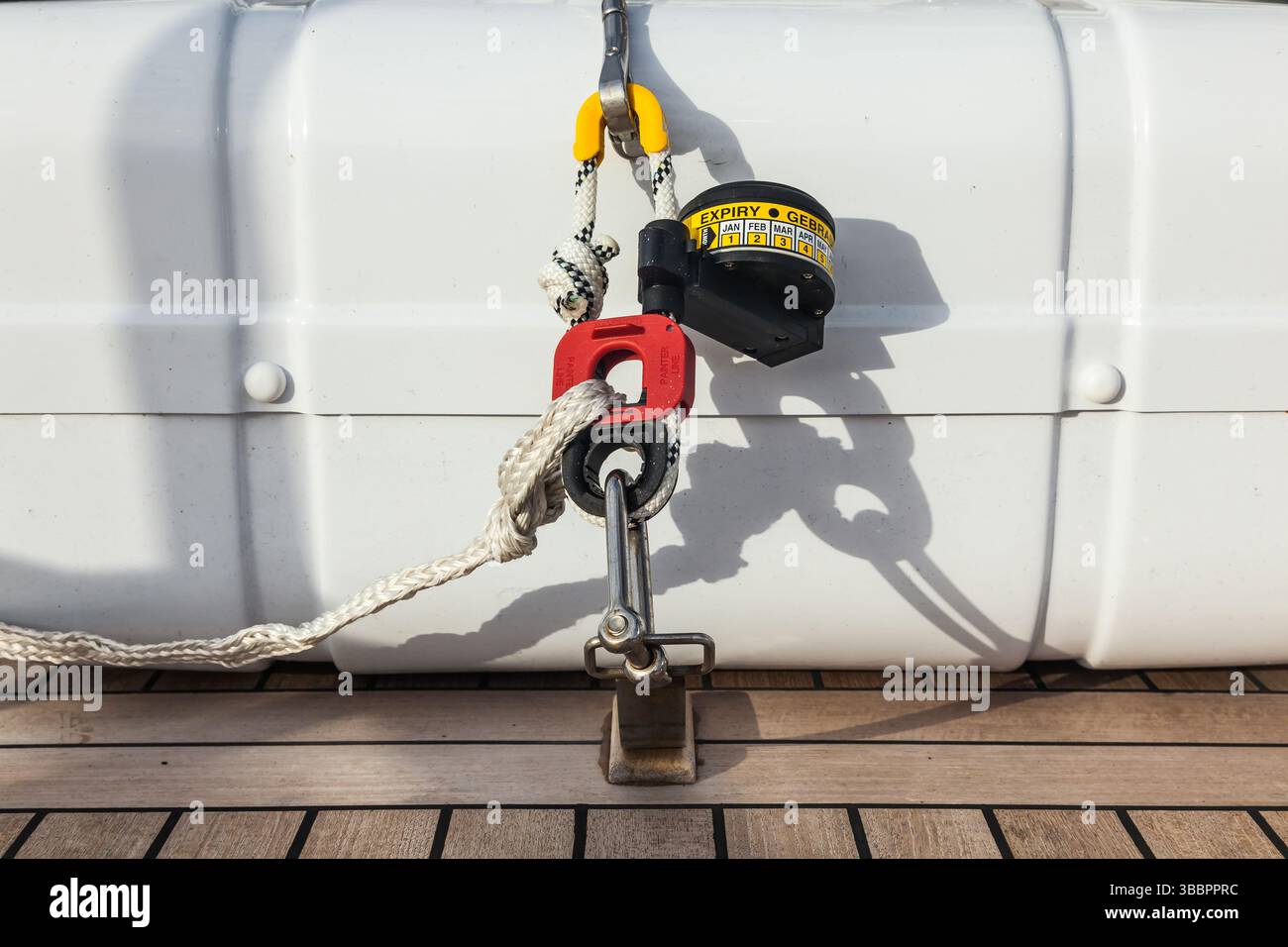 Life raft in capsules are fixed on the teak deck of the yacht in close ...