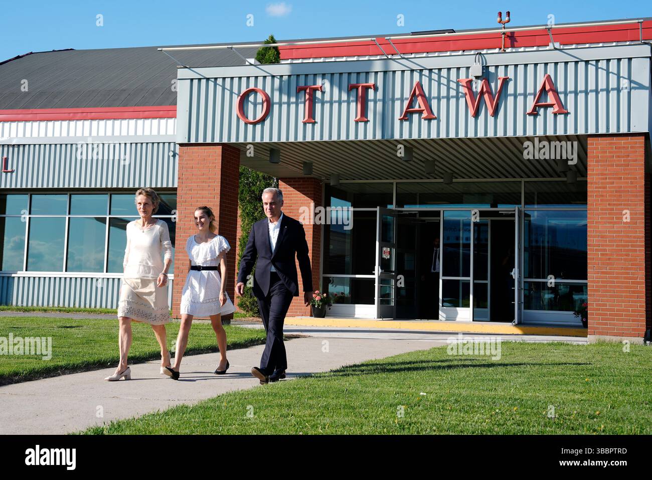 Prime Minister Mark Carney boards a government plane with his wife ...
