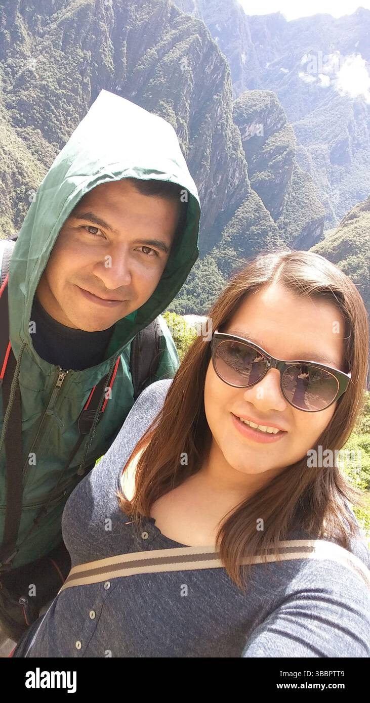 A 30-year-old Latino man and woman couple travel and explore Machu Picchu, Peru, as an ...