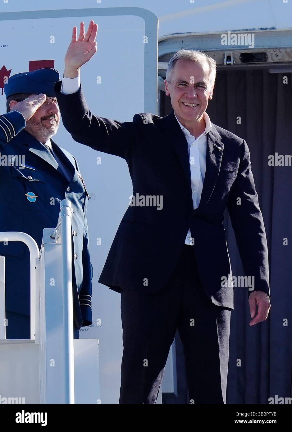 Prime Minister Mark Carney boards a government plane in Ottawa, Friday ...