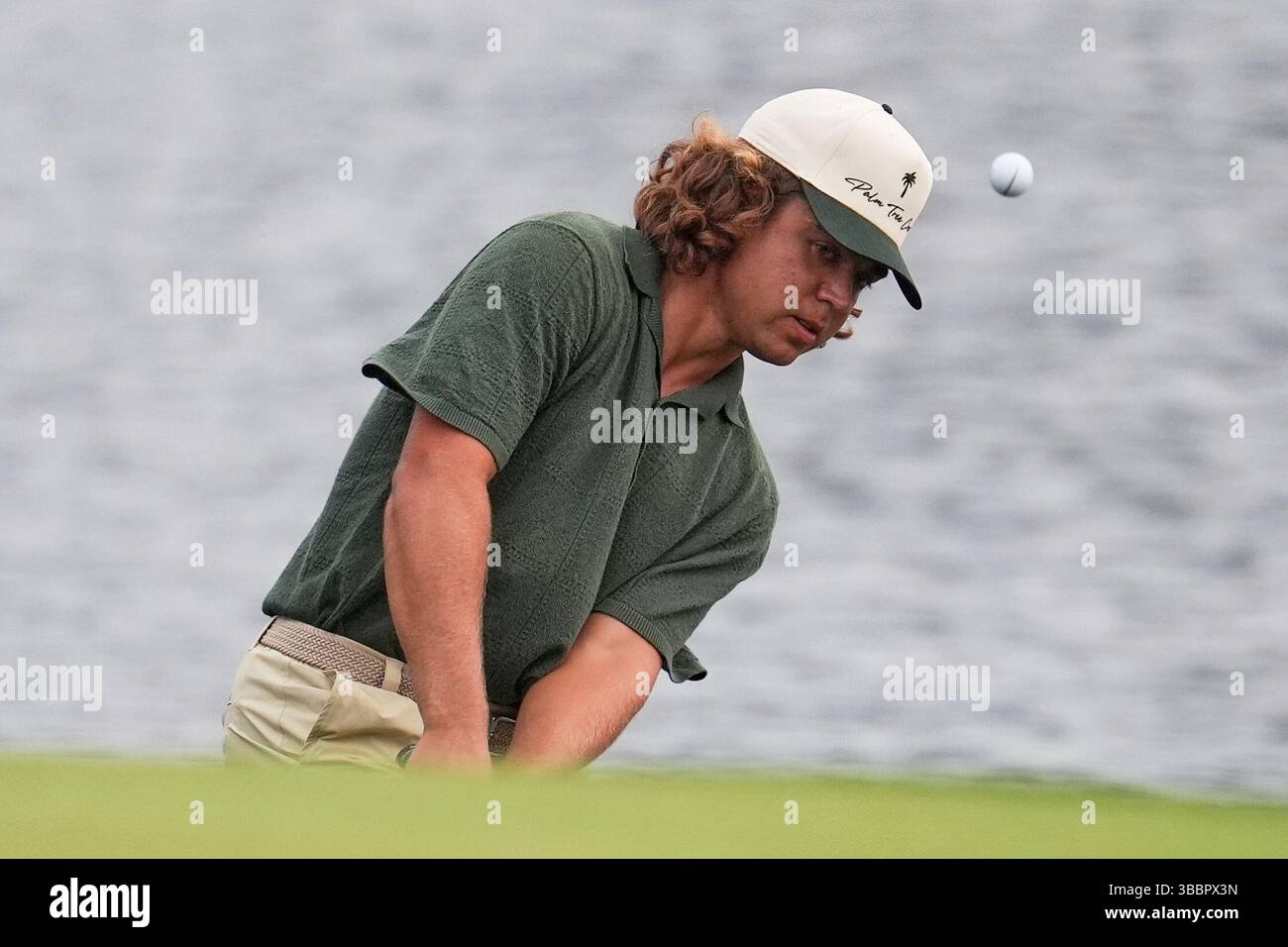 Garrick Higgo, of South Africa, chips to the green on the 14th hole ...