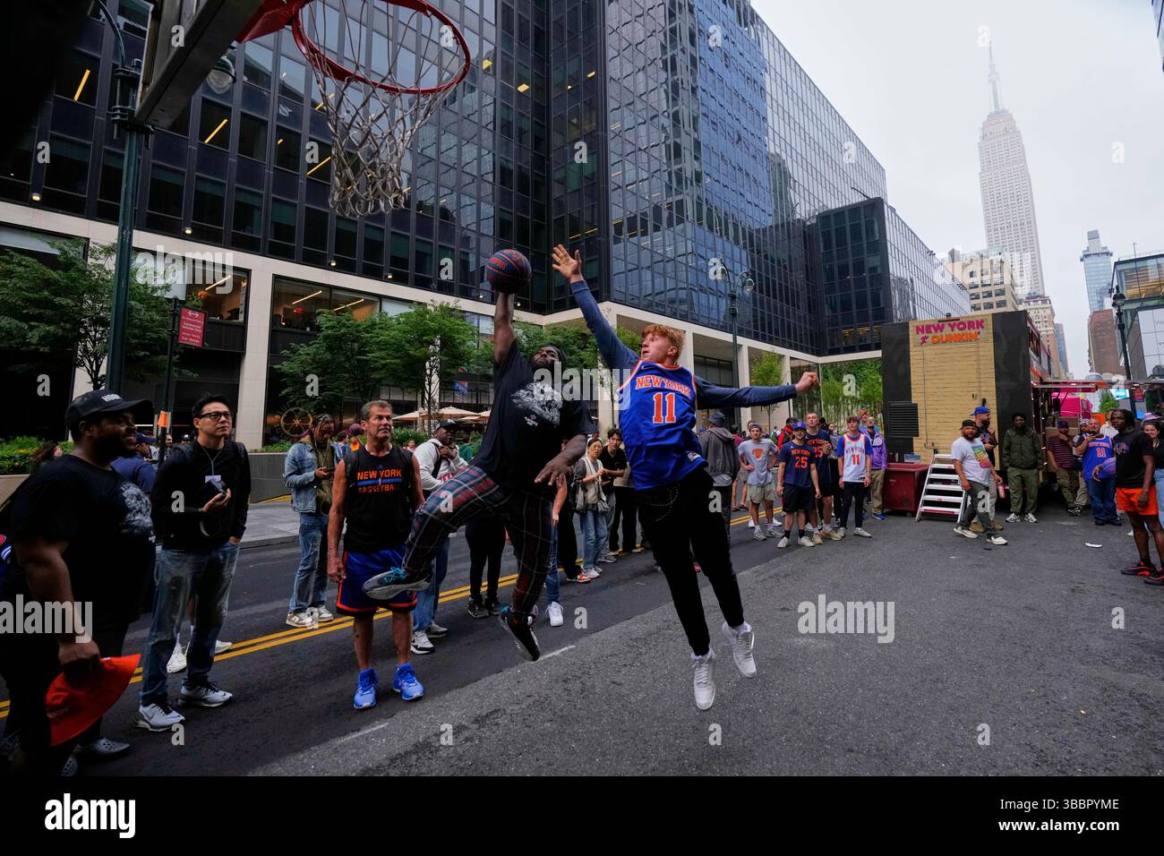 Fans watch a basketball game as they enjoy the New York Block Party ...