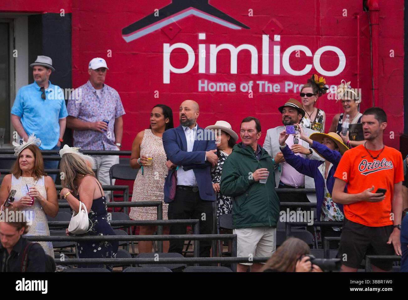 Spectators watch the 149th running of the Black-Eyed Susan horse race ...