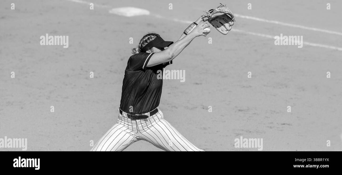 A Fast Pitch Softball Pitcher Is In Full Wind Up Pitching The Ball ...
