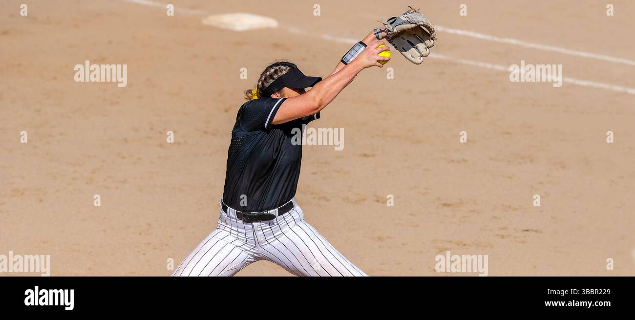 A Fast Pitch Softball Pitcher Is In Full Wind Up Pitching Header Banner ...