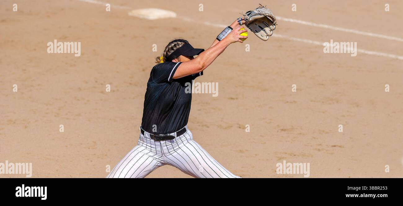 A Fast Pitch Softball Pitcher Is In Full Wind Up Pitching Header Banner ...