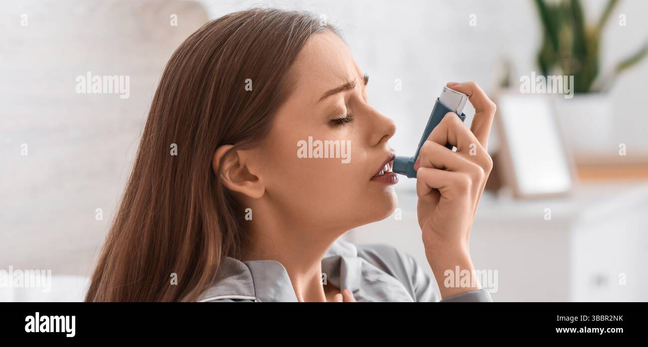 Sick young woman with inhaler in bedroom Stock Photo - Alamy