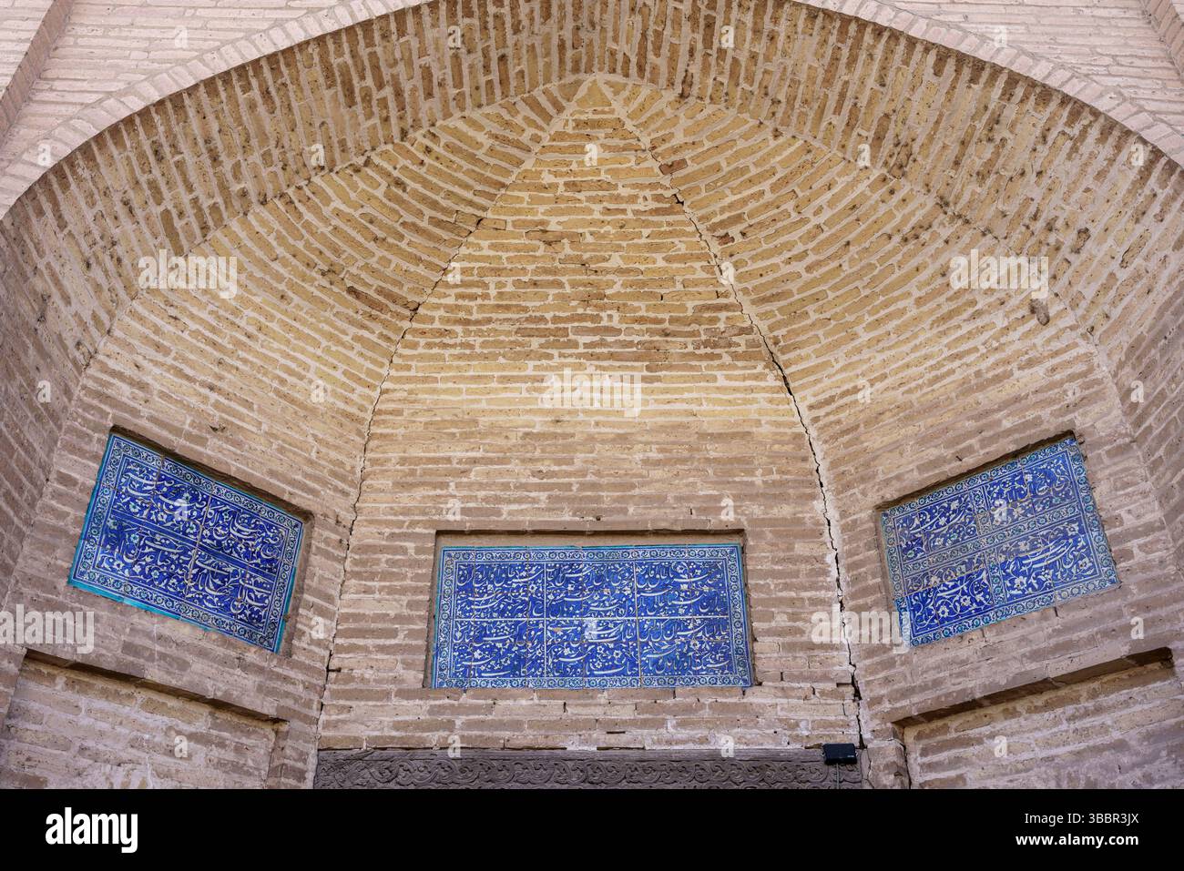 A domed ceiling with blue mosaic windows and brick patterns decorates ...