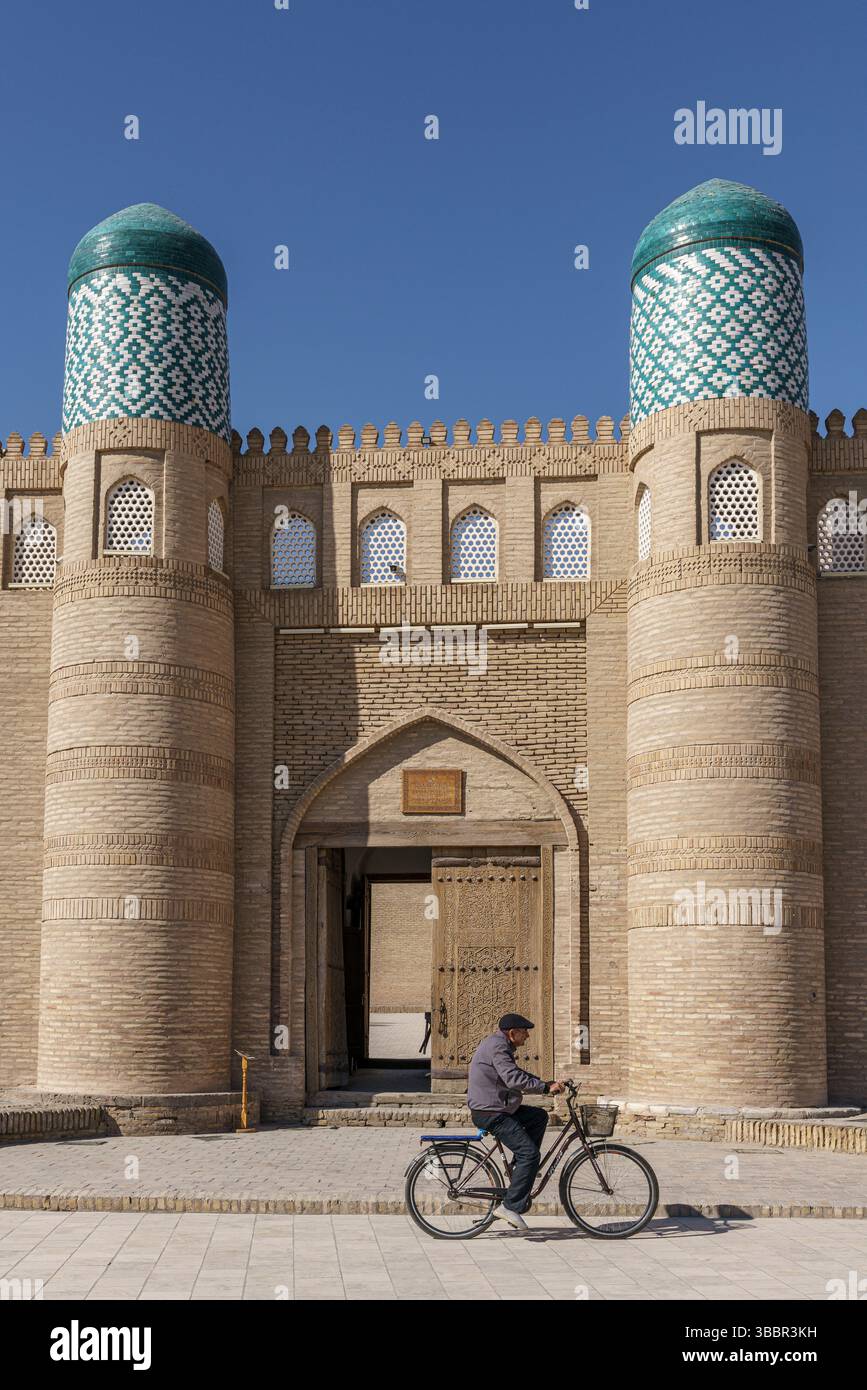 A monumental arched gate with blue tilework marks the entrance to Kuhna ...