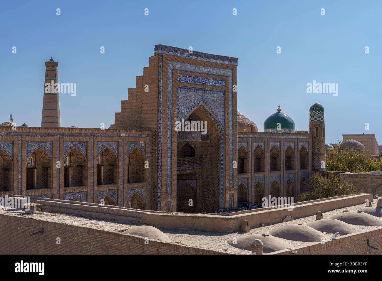 A tall minaret and blue tiled entrance stand beside Muhammad Rahim Khan ...