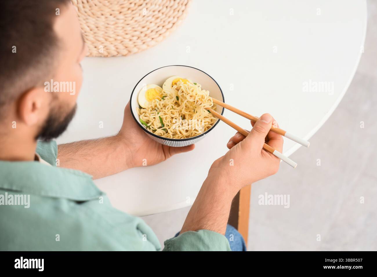 Person eating ramen chopsticks table hi-res stock photography and ...