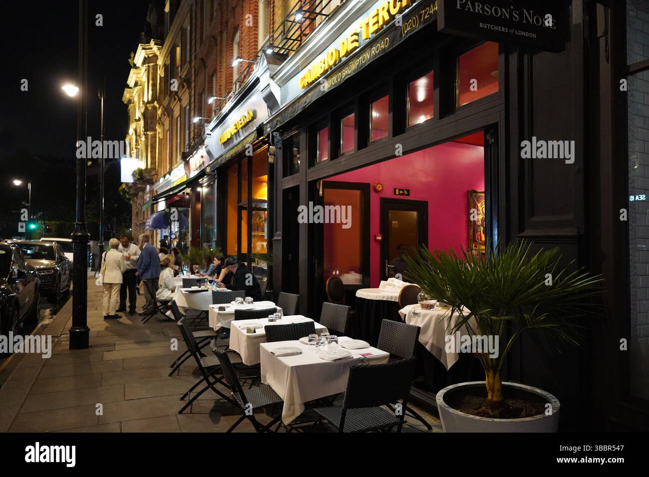 Outdoor restaurant or pub tables on sidewalk on a summer night Stock ...