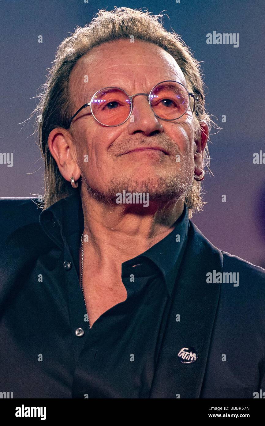 Bono poses for photographers upon departing the premiere of the film ...