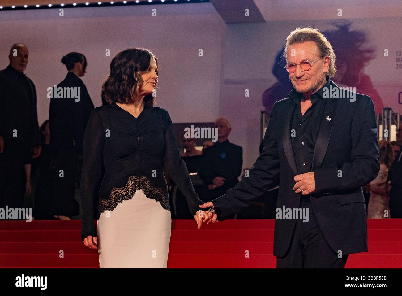 Bono and Ali Hewson pose for photographers upon departing the premiere ...