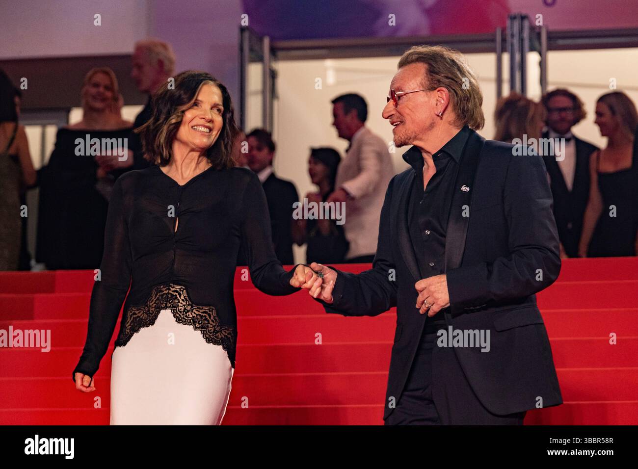 Bono and Ali Hewson pose for photographers upon departing the premiere ...