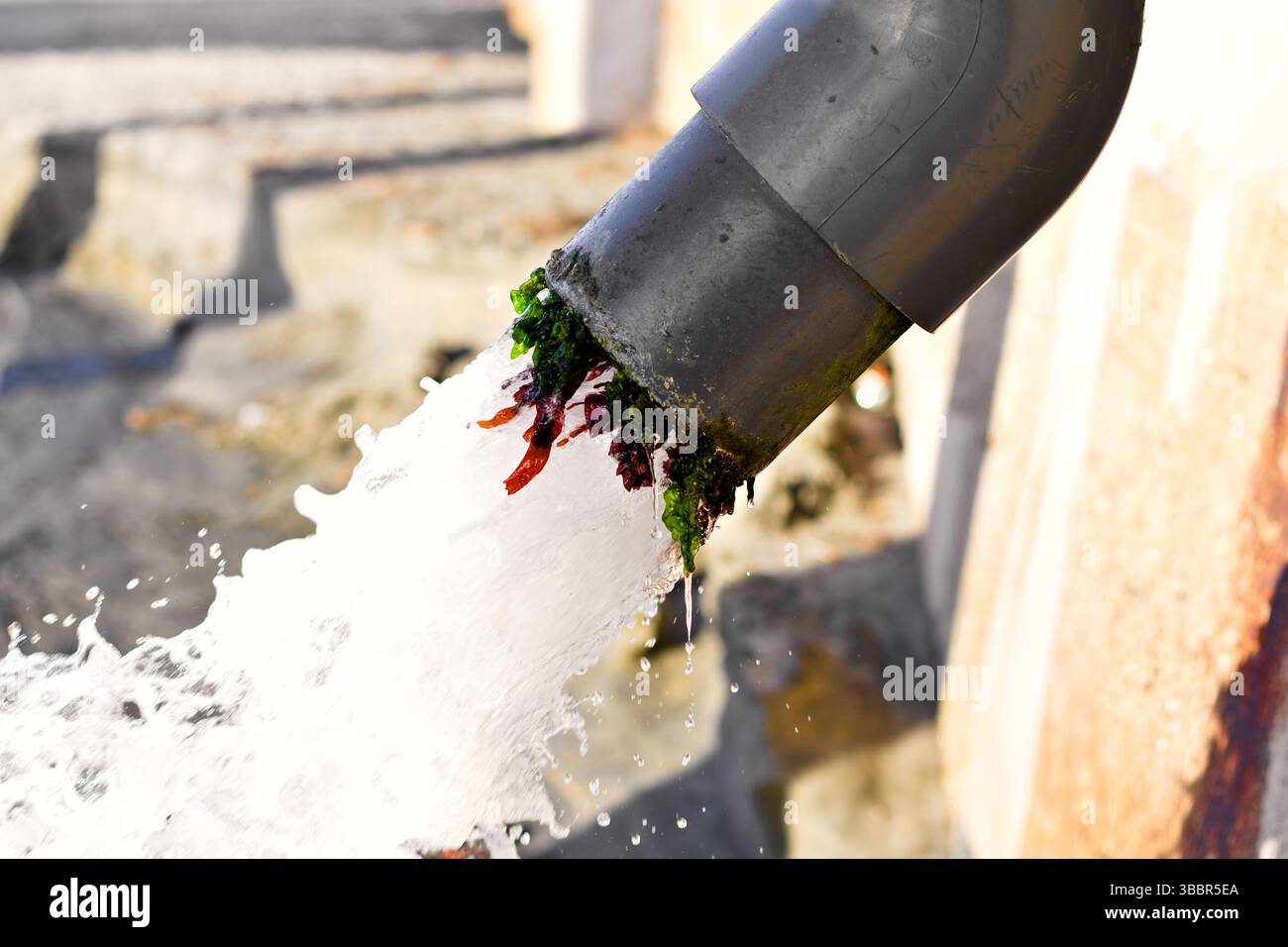 Seawater flowing out of a pipe Stock Photo - Alamy