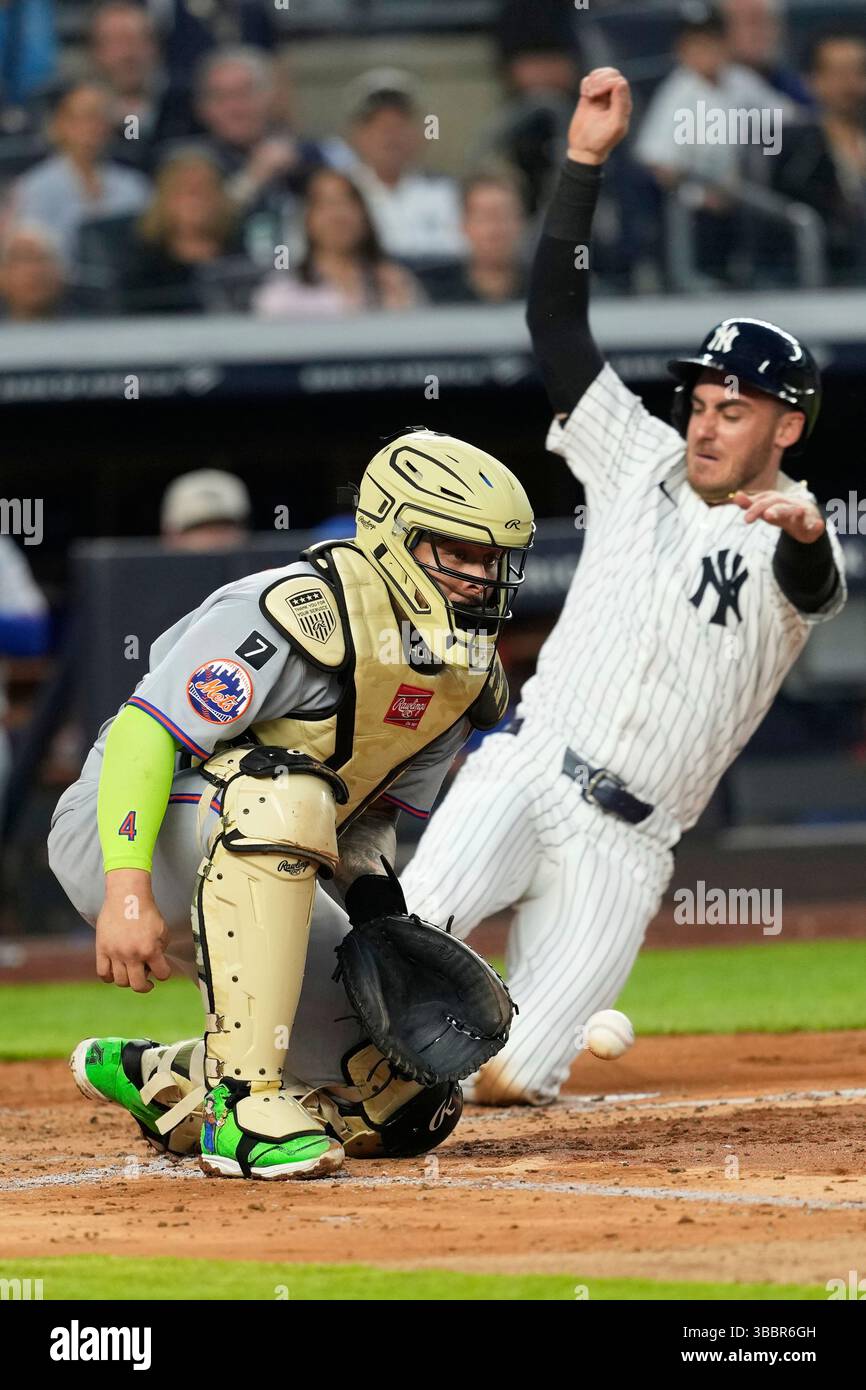 New York Yankees' Cody Bellinger, right, slides safely home in front of New York Mets catcher ...