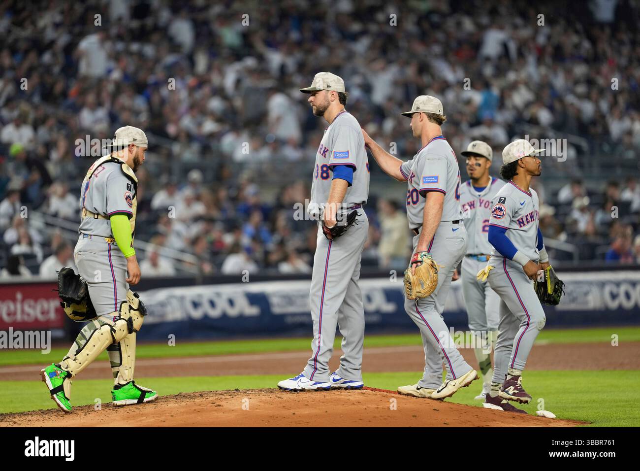 New York Mets pitcher Tylor Megill, second from left, is pulled form ...
