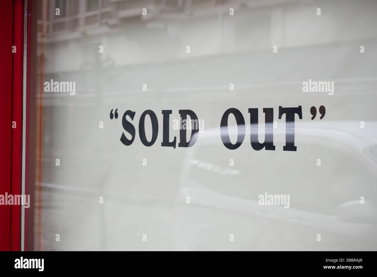 Shop display shows sold out sign on window Stock Photo - Alamy