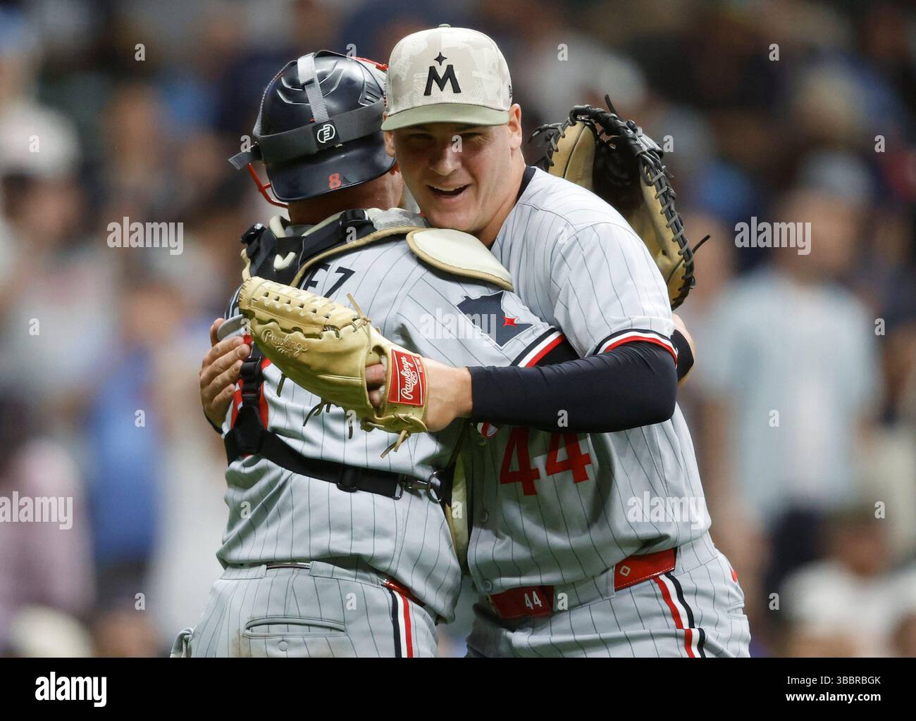 Minnesota Twins' Cole Sands, right, reacts with Christian Vazquez, left ...