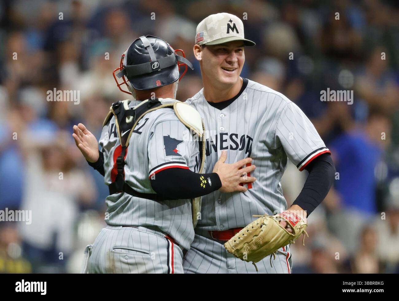 Minnesota Twins' Cole Sands, right, reacts with Christian Vazquez, left ...