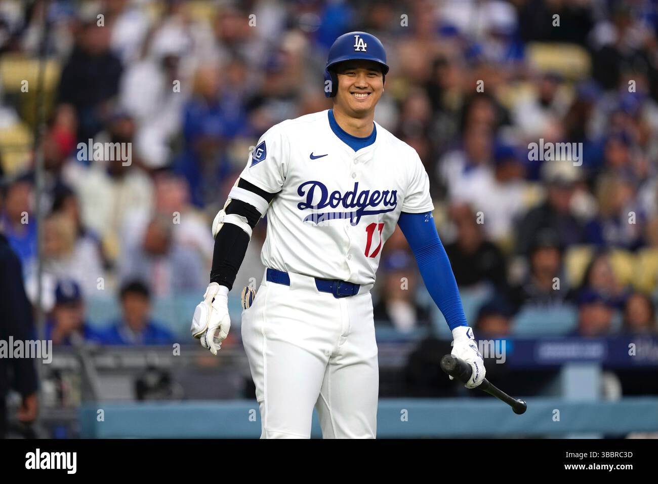 Los Angeles Dodgers' Shohei Ohtani smiles toward the Los Angeles Angels ...