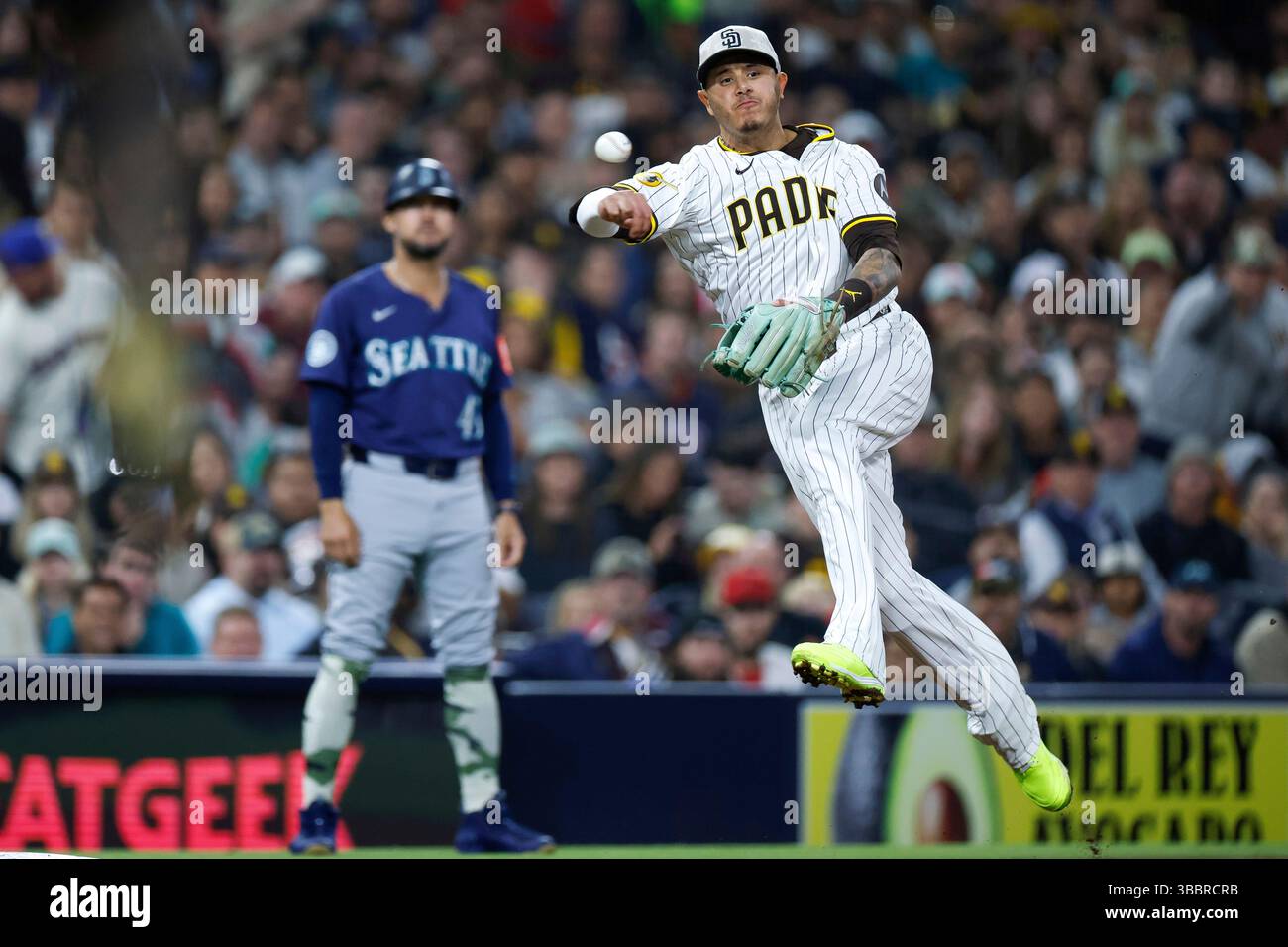 San Diego Padres third baseman Manny Machado, right, throws to first on ...