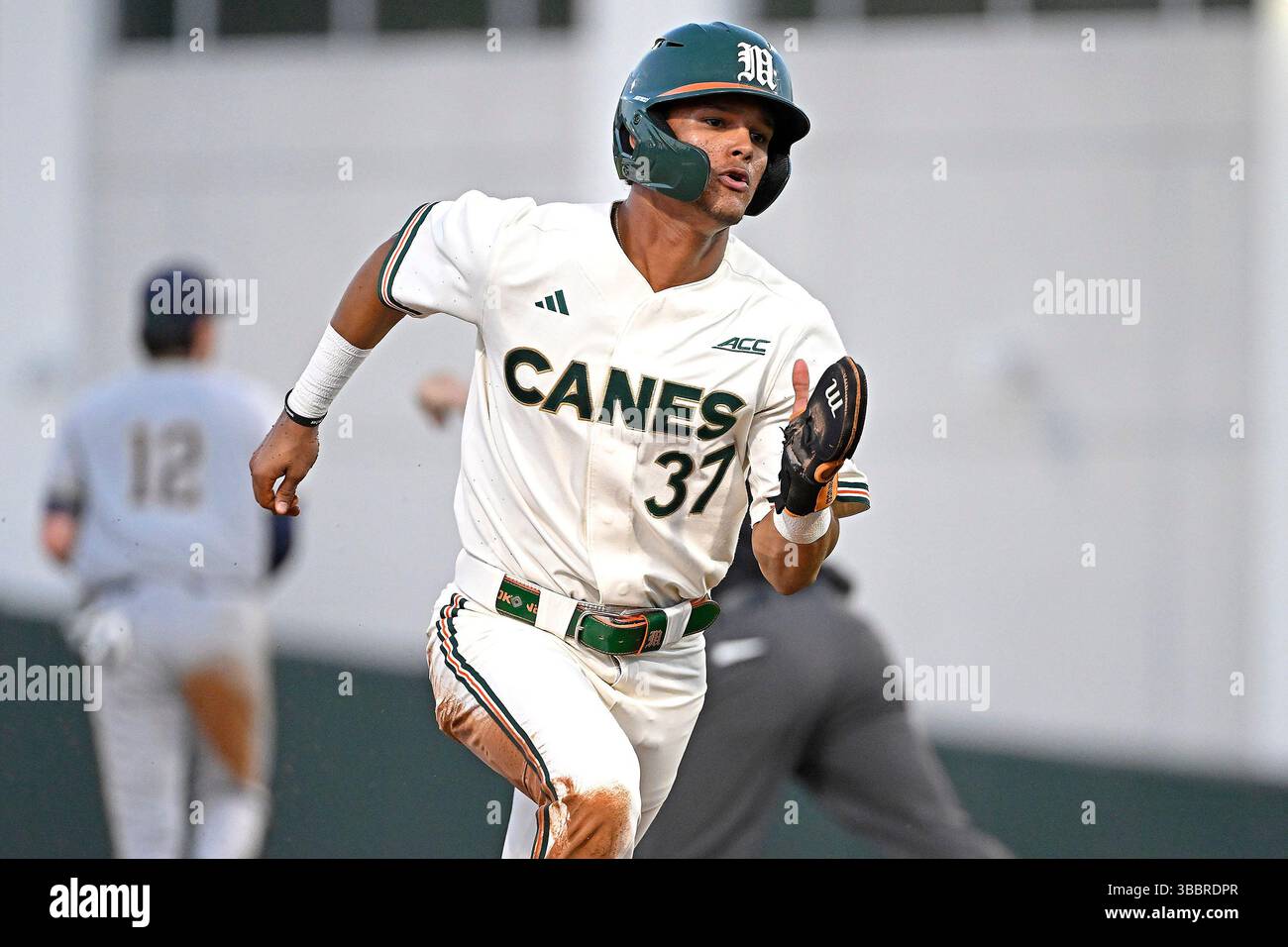CORAL GABLES, FL - MAY 16: Miami outfielder Fabio Peralta (37) runs to ...