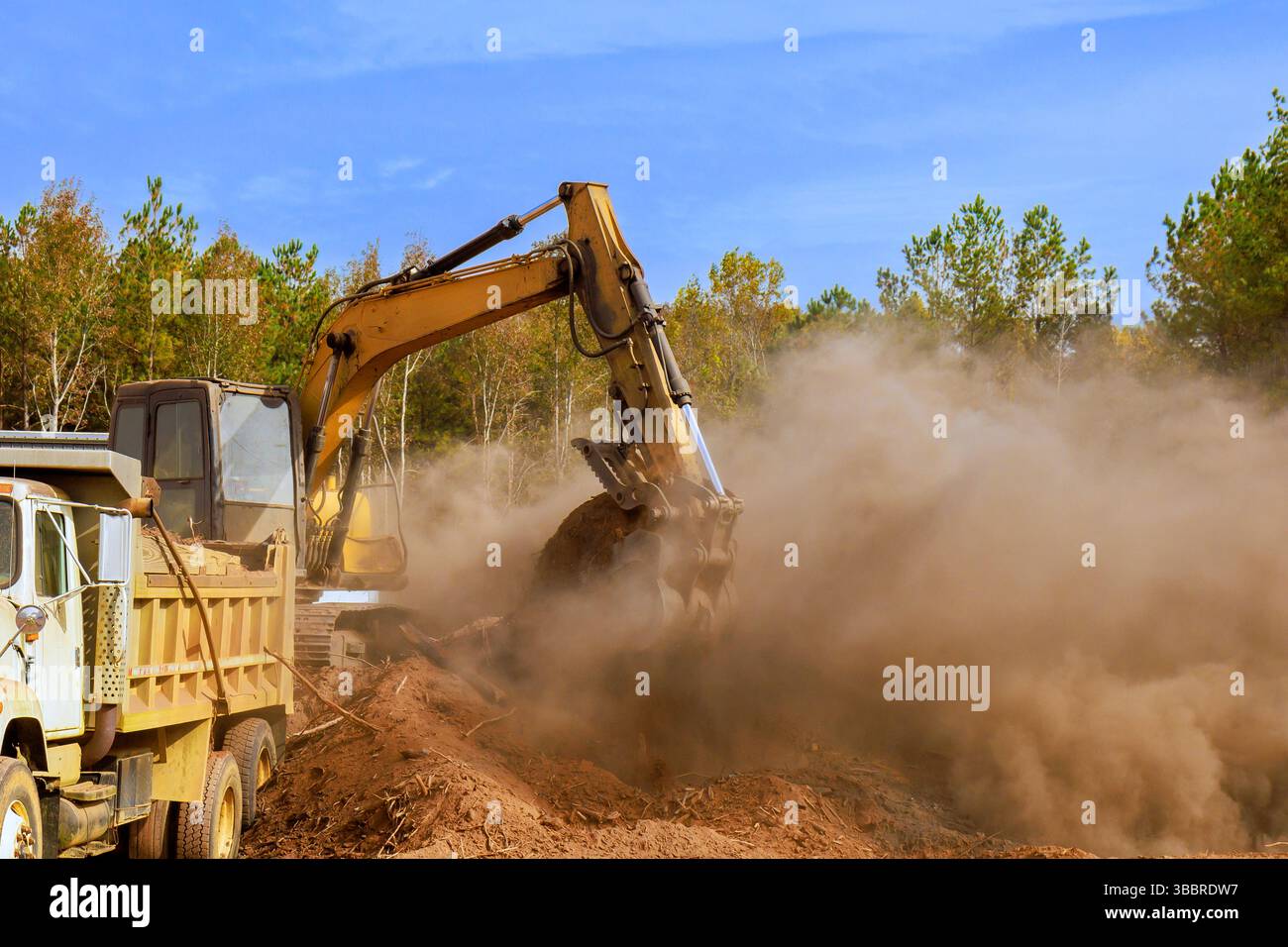 Heavy machinery clears soil tree removal, at construction site ...