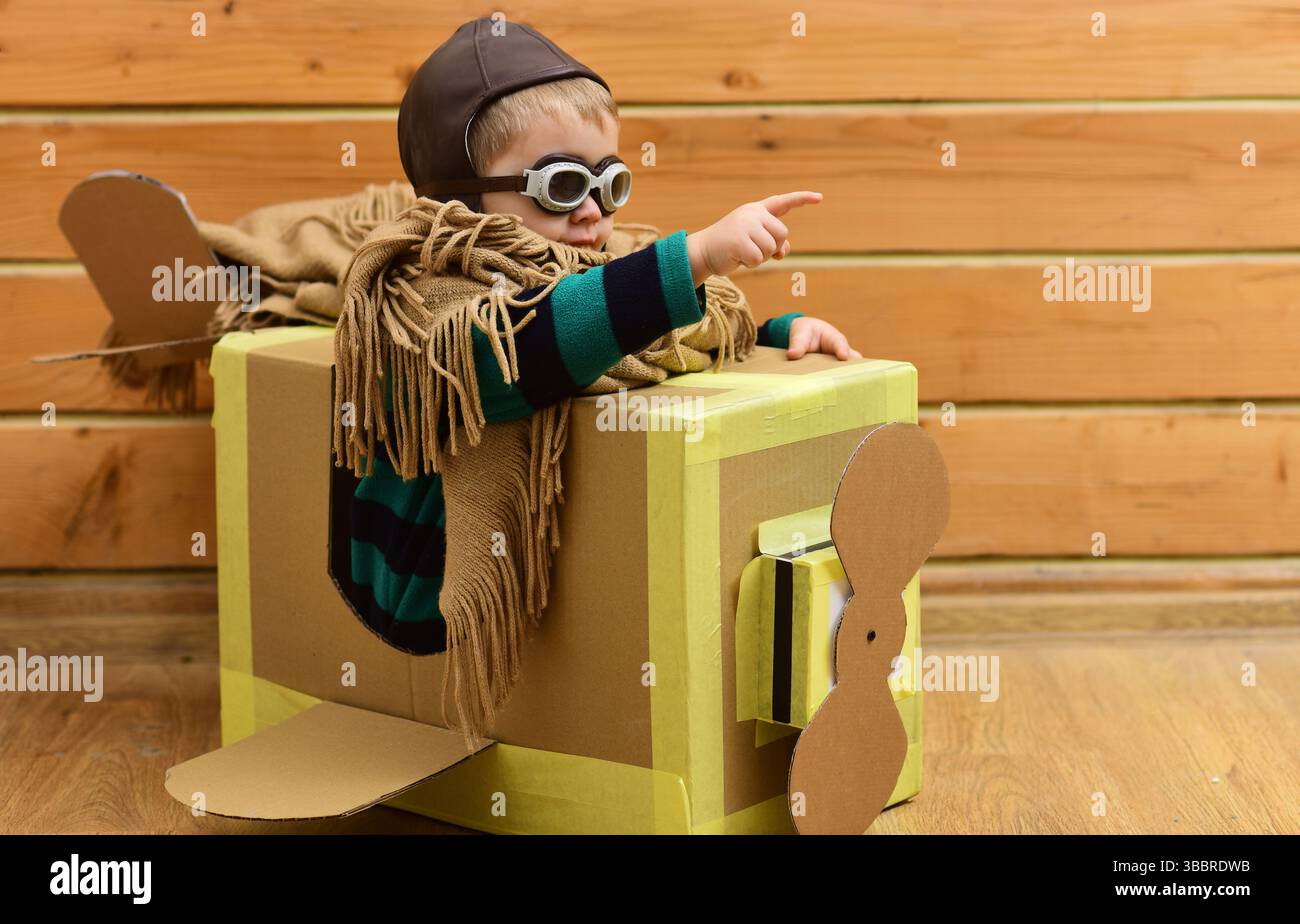 Flying child flying with cardboard wings. Kid dreams of pilot. Baby fly ...