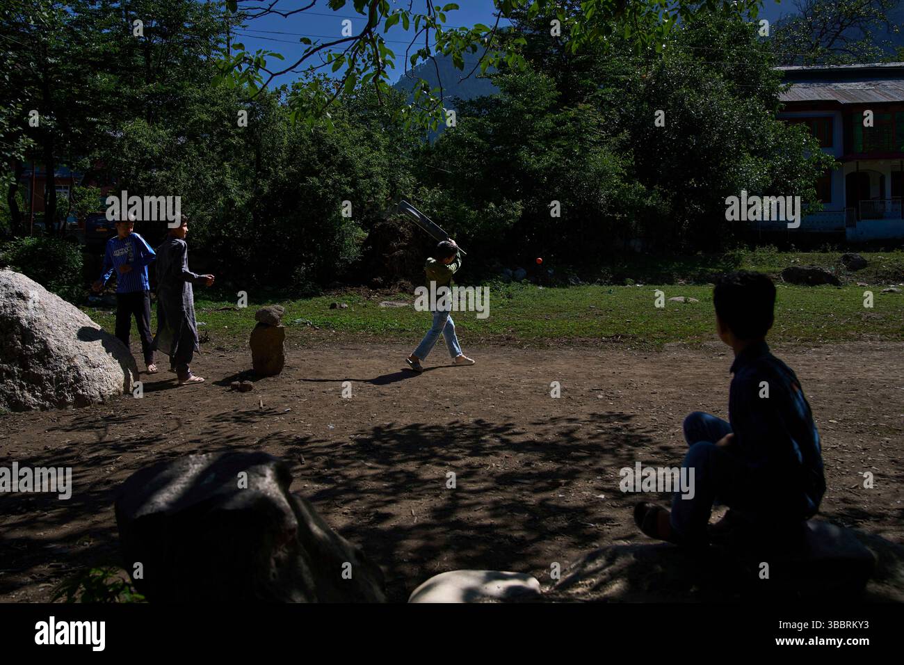Kashmiri children play cricket in the border village of Gingal, north ...