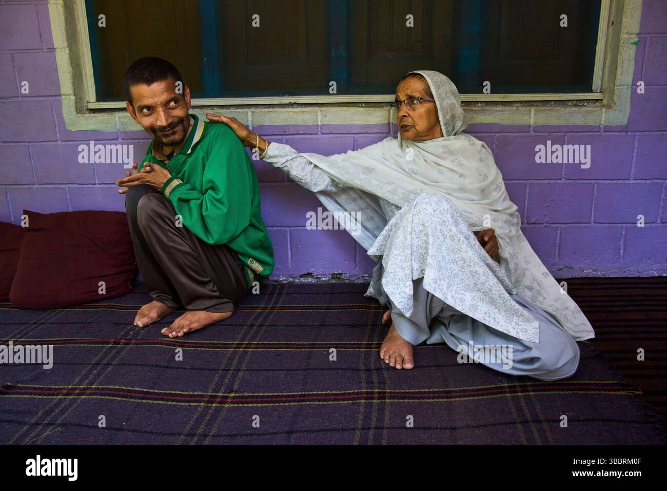 Nasreena Begum, right, talks with her special-needs son Manzoor Ahmed ...