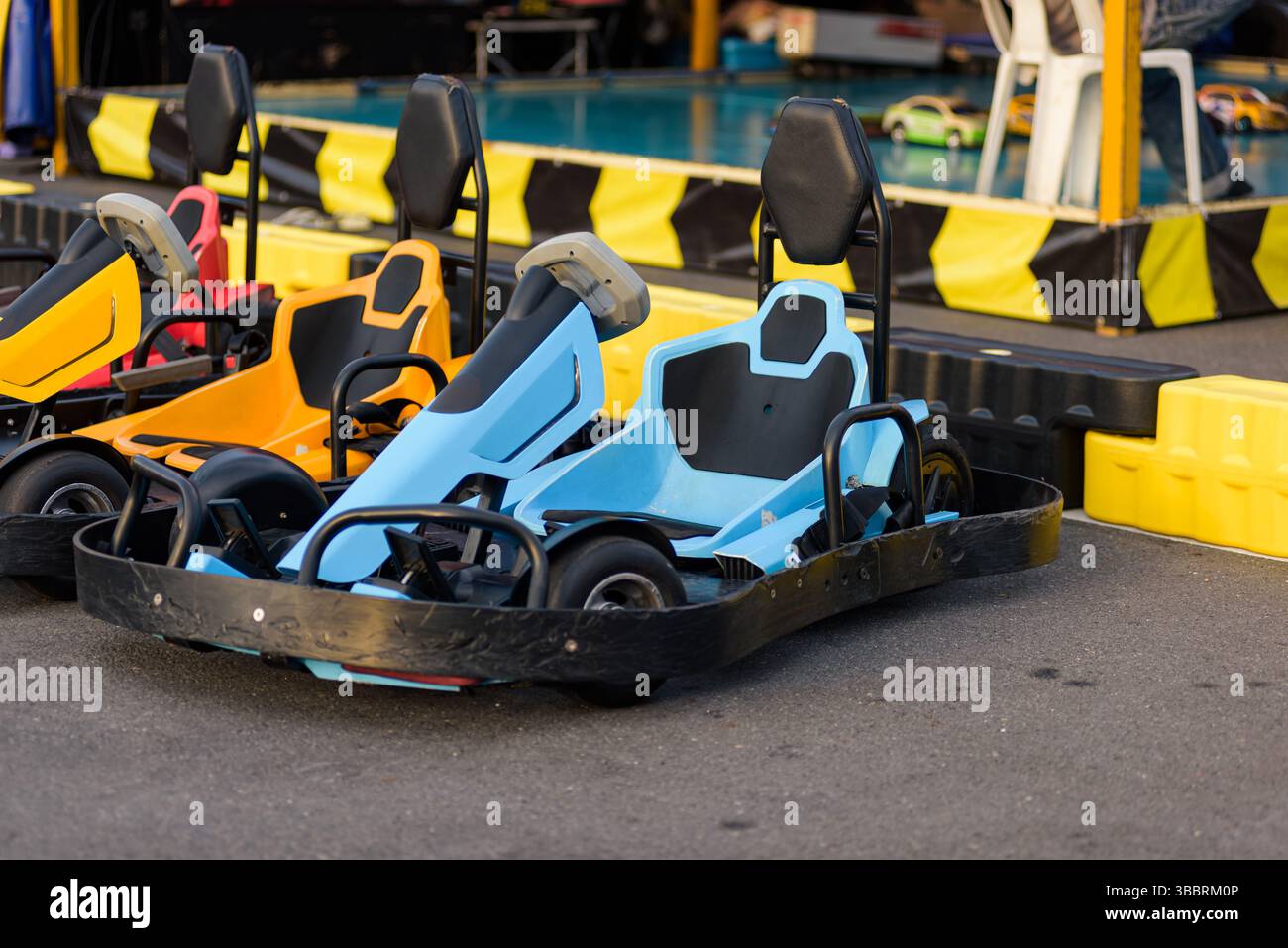 Go-kart race day. Drivers prepare as go kart machines are positioned ...