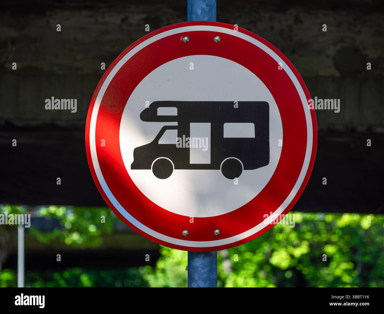 A circular traffic sign with a red border and a black silhouette of a ...