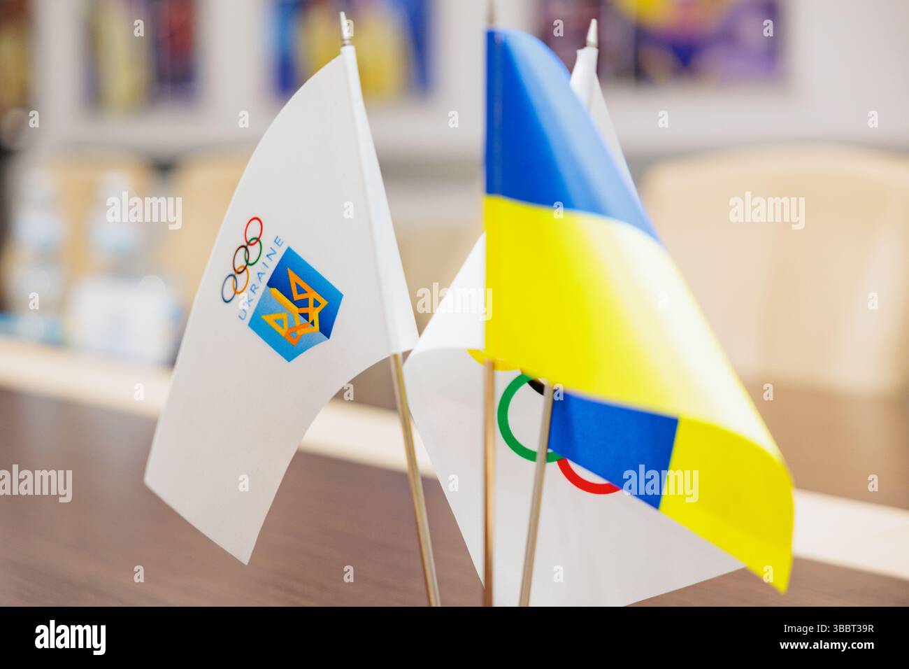 Ukrainian flag and Olympic Committee flag stand on a table during a ...