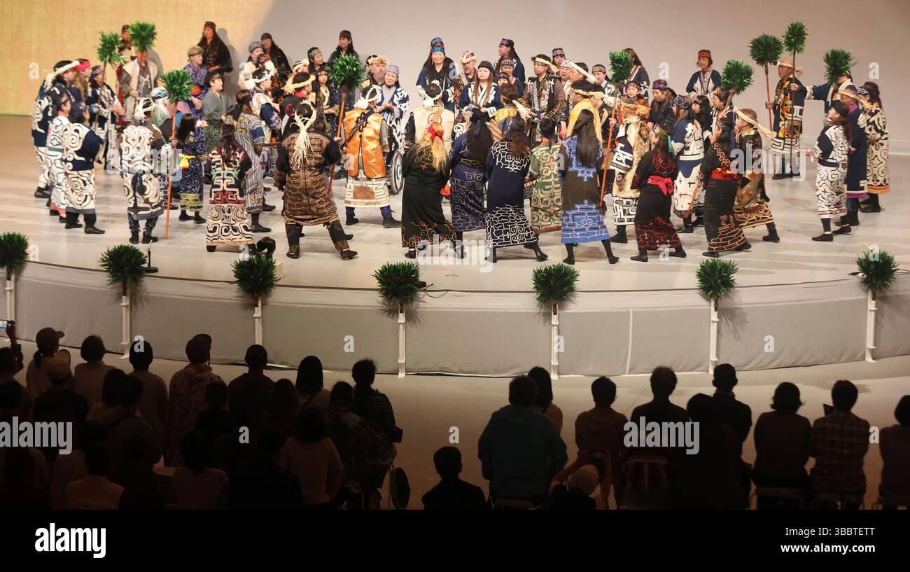 Dancers wearing Ainu folk costumes perform the ethnic dance during an ...