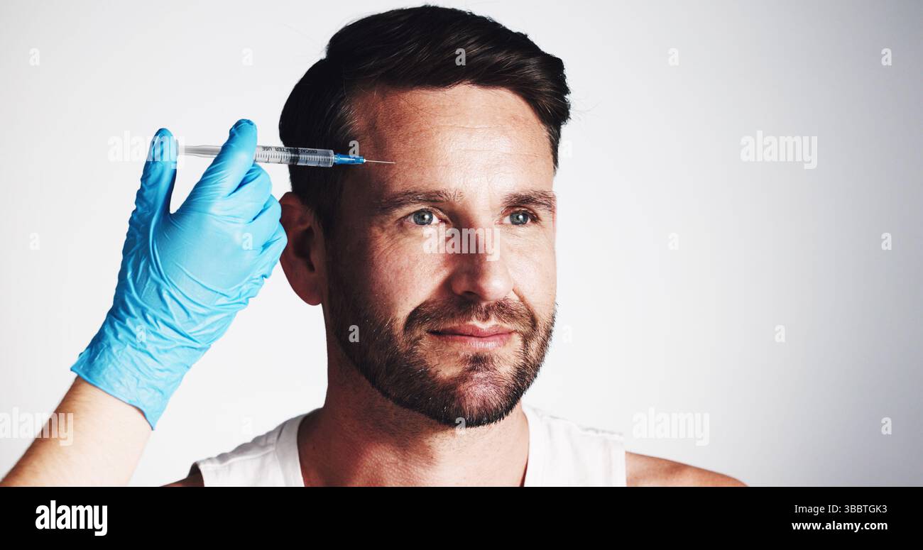 Forehead, needle and beauty with man in studio for filler injection ...
