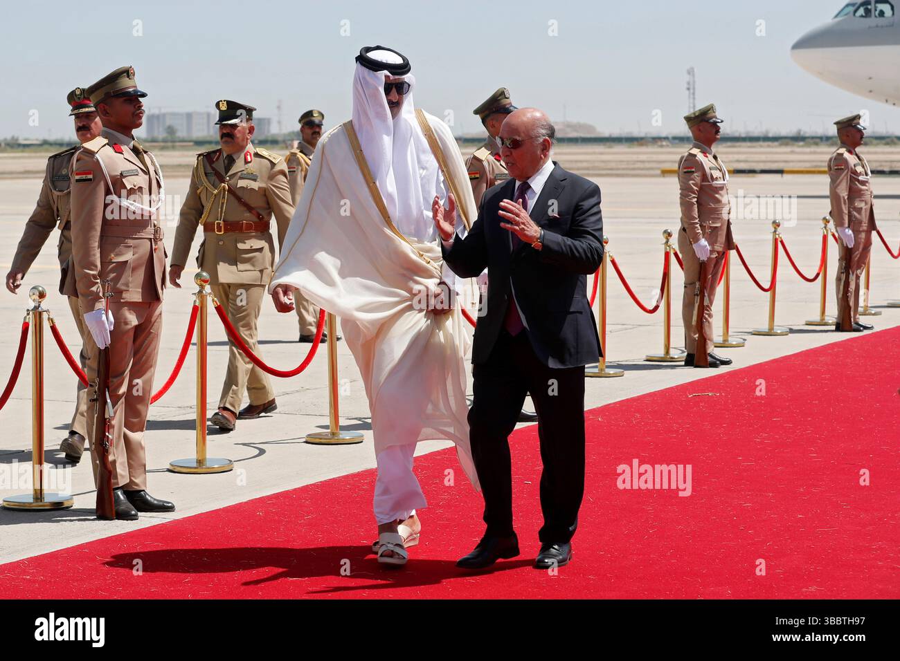 Iraq's Foreign Minister Fuad Hussein, right, walks with Qatar's Emir ...