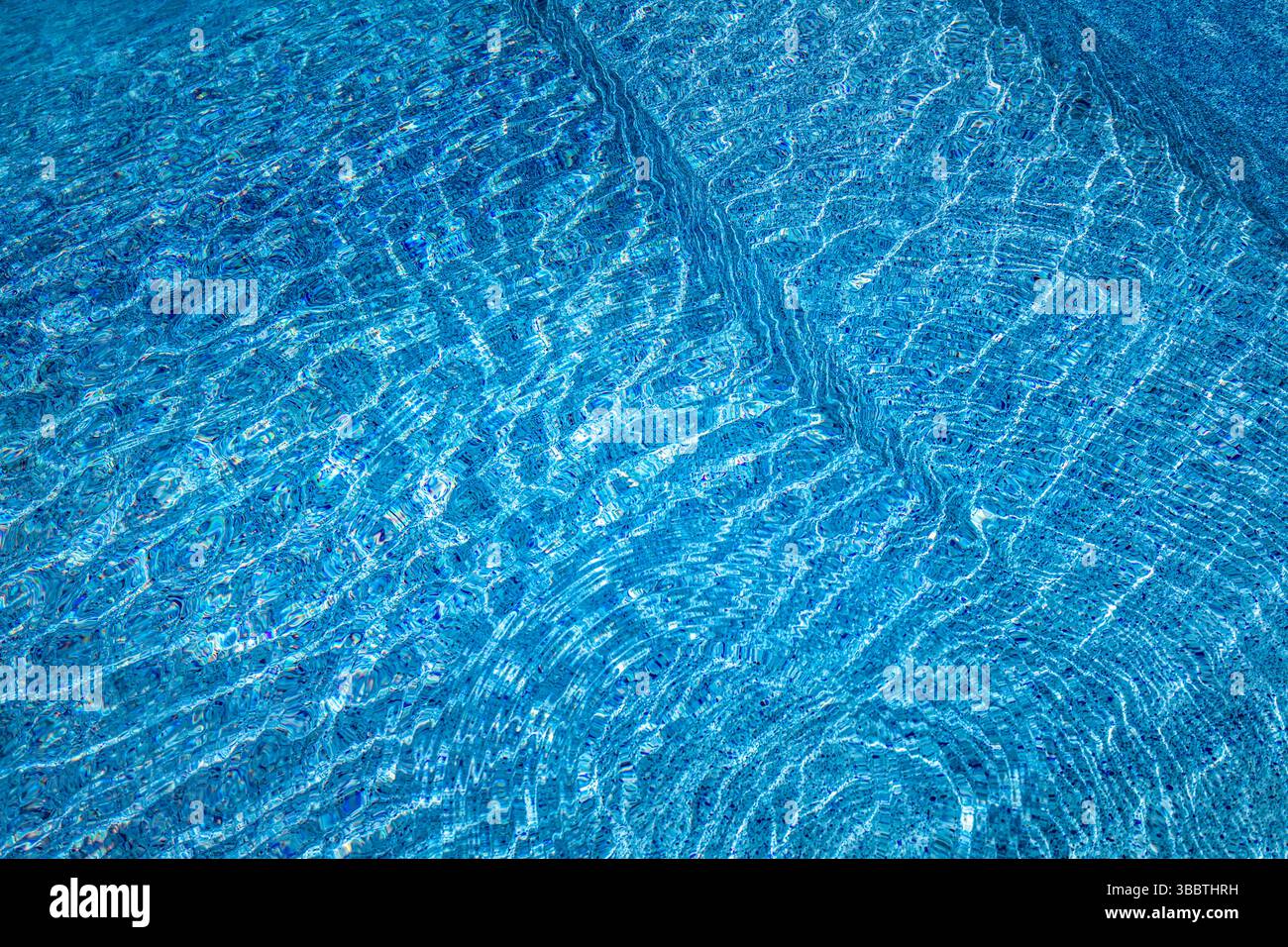 Artistic abstract pool water background blue ripples and sunshine reflections creating peaceful ...