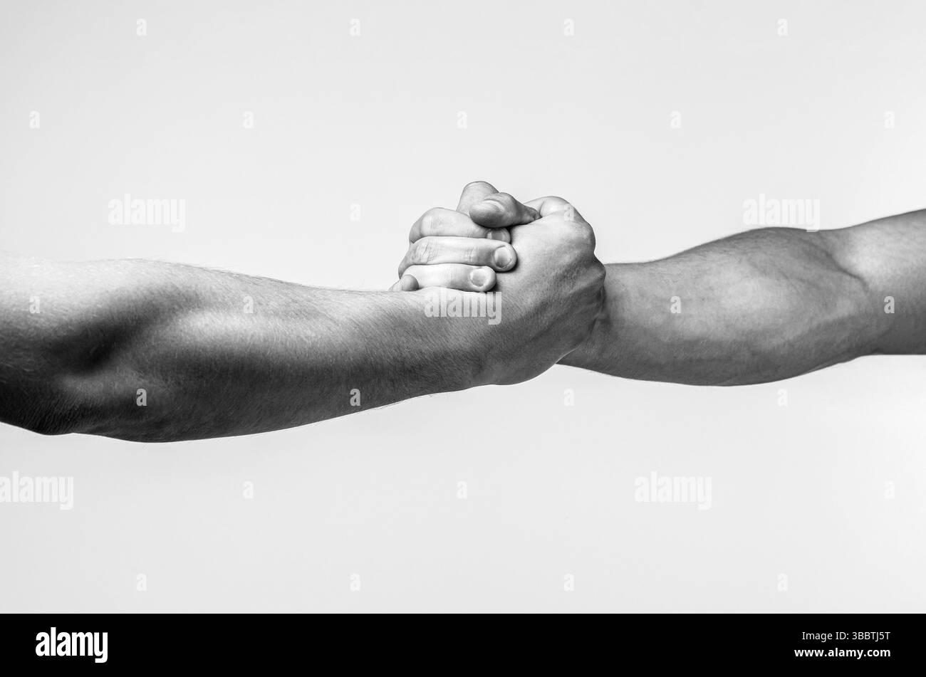 Man helping another man climb Black and White Stock Photos & Images - Alamy