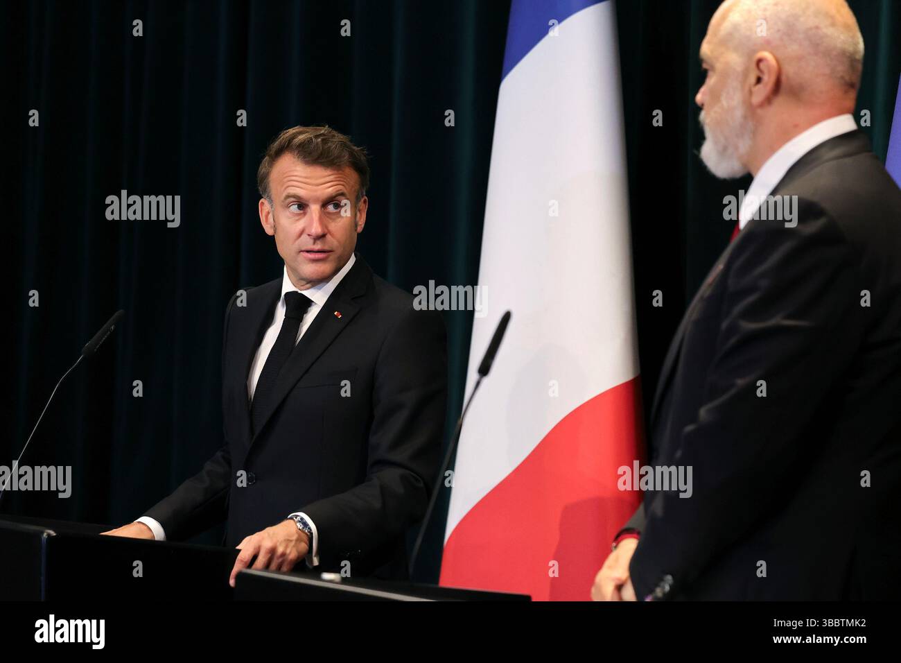French President Emmanuel Macron, left, addresses journalists during a ...