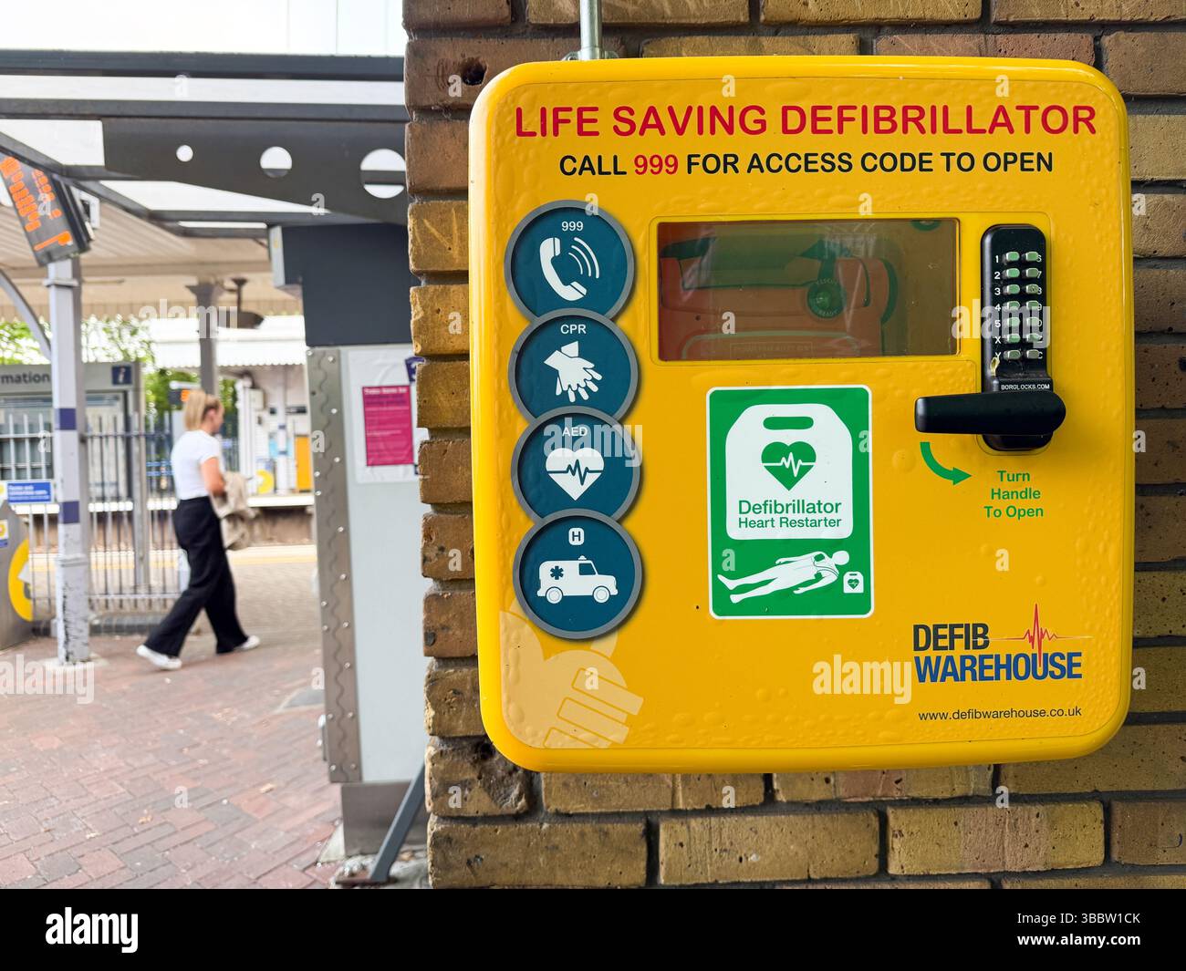 Front view of a life-saving defibrillator mounted on the exterior wall ...