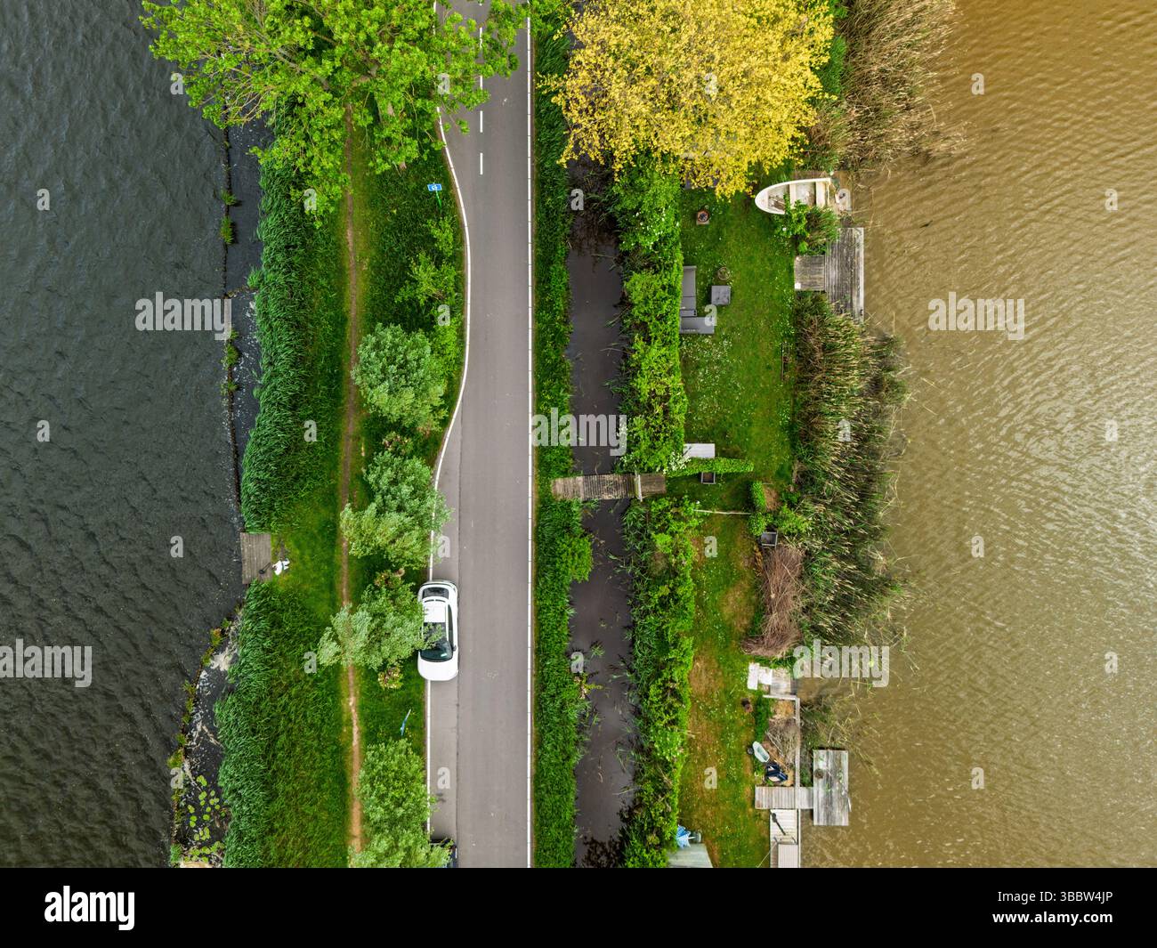 Top-down aerial view of a narrow road running between two bodies of ...