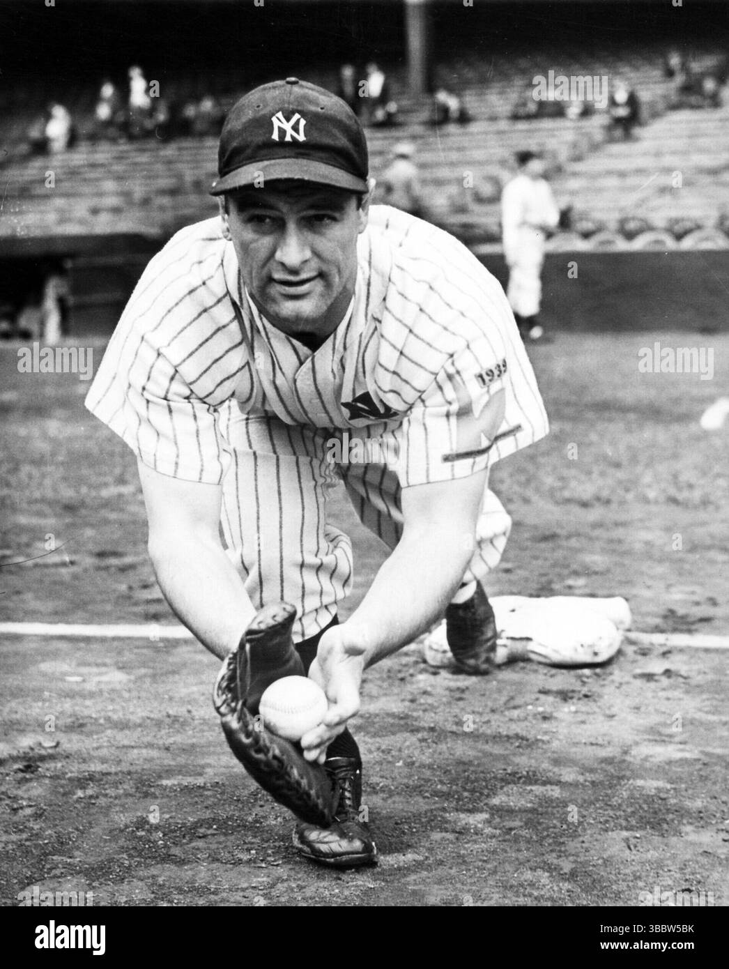 Lou Gehrig poses on first base with a ball in hand before a game in ...